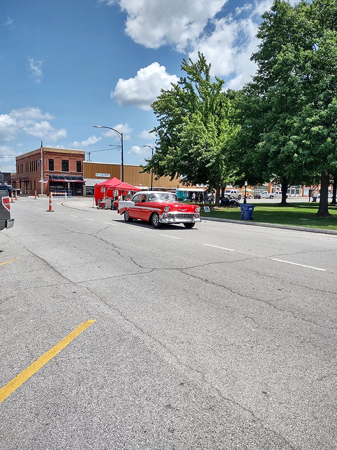 Classic Americana unfolds on Main Street, where a vintage Chevy cruises past storefronts that have weathered decades of change yet maintained their small-town charm.