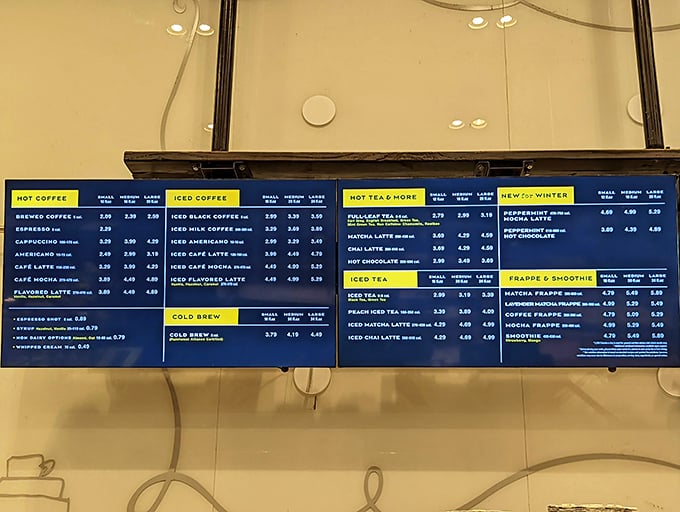 The menu board reads like a United Nations of caffeine – from classic Americanos to matcha lattes – perfect companions for your inevitable pastry indulgence.