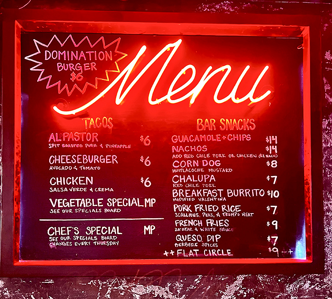 Menu magic in neon red. The "Domination Burger" might sound intimidating, but it's the al pastor tacos that truly rule this roost.