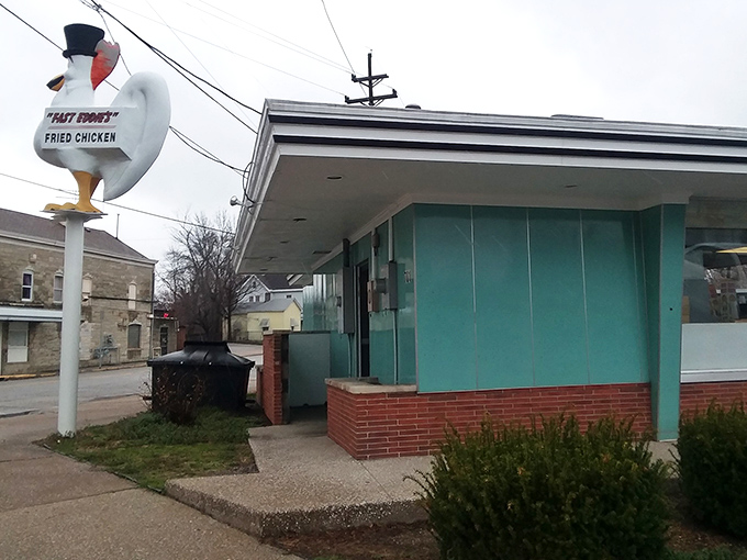 That top-hatted chicken statue isn't just kitsch—it's a beacon of hope for the hungry, standing tall against the Illinois sky like a deep-fried lighthouse.
