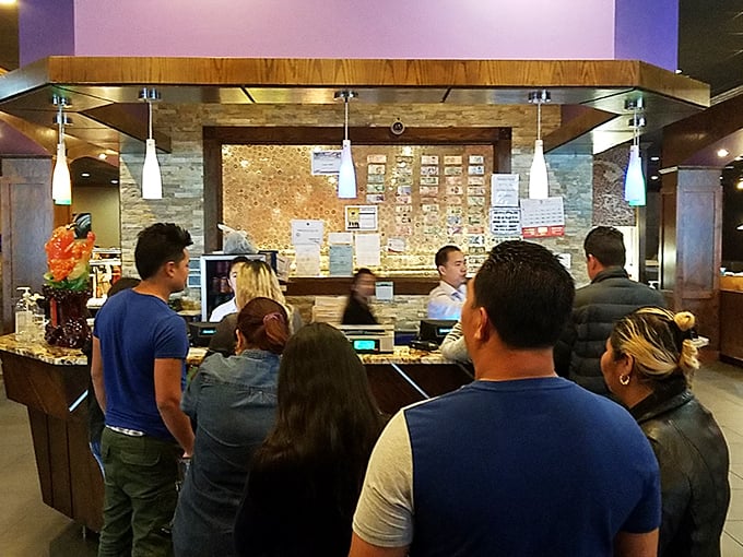The bustling front counter, where hungry patrons queue with the focused determination of marathon runners approaching the finish line.
