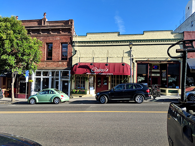 Cirino's red awning beckons hungry visitors like a culinary lighthouse in a sea of historic architecture, promising Italian comfort and local conversation.