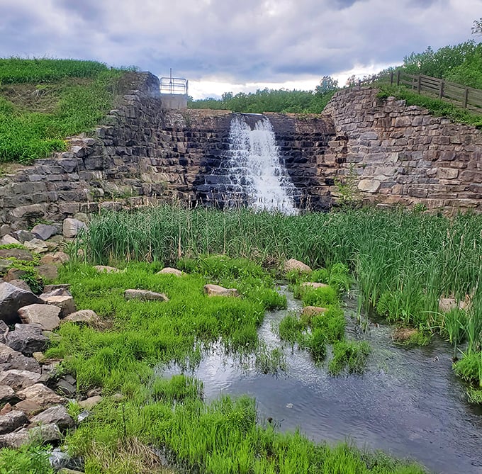 This historic stone dam waterfall doesn't just flow, it performs &ndash; nature's version of Broadway complete with dramatic cascades and verdant supporting cast.