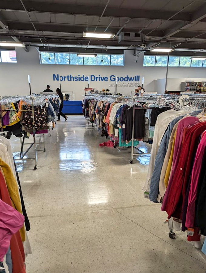 The Northside Drive Goodwill's clothing section stretches toward the horizon like a fabric sea of second chances.