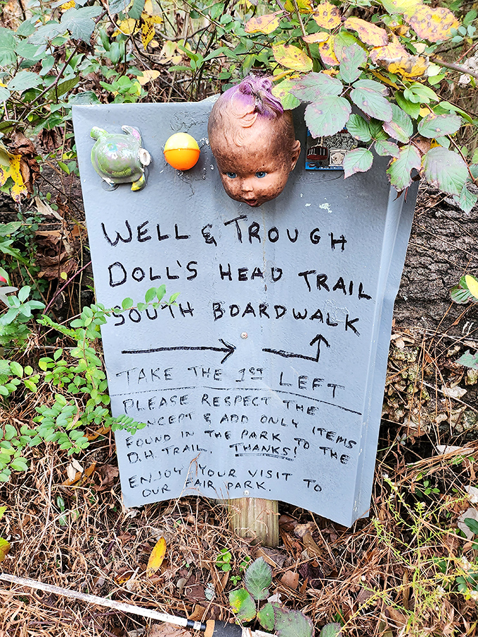 Even the trail signage embraces the artistic vision, with doll parts serving as both decoration and silent guides.