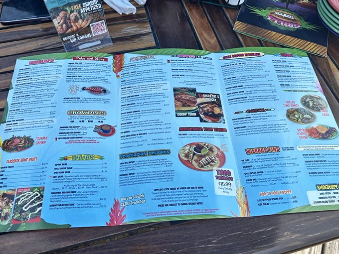 A menu that requires strategic planning. Like a treasure map where X marks the spot for seafood bliss and tropical cocktails.