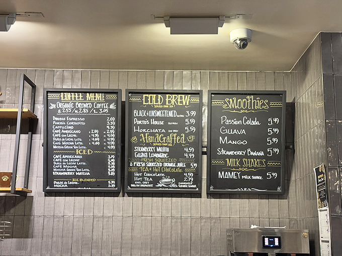 The menu board reads like poetry to coffee lovers. Each beverage promising the perfect companion to whatever sweet treasure awaits.