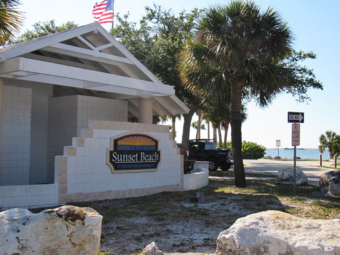 The unassuming entrance belies the paradise beyond. Like finding a Michelin-starred restaurant in a strip mall, Sunset Beach's modest sign promises understated excellence.