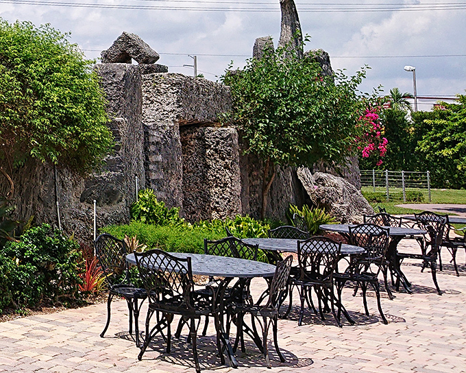 Modern patio furniture meets ancient megalithic backdrop. The juxtaposition feels like having coffee in Stonehenge's hip younger cousin.