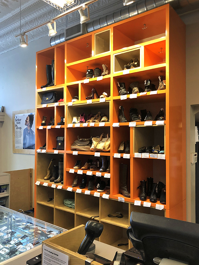 The signature orange display shelves showcase footwear finds ranging from barely-worn designer boots to quirky vintage kicks worth building an outfit around.
