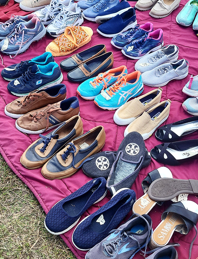 A fashionista's dream spread across vibrant pink fabric. Those turquoise ASICS and designer flats aren't just shoes&mdash;they're previous lives waiting for new adventures.