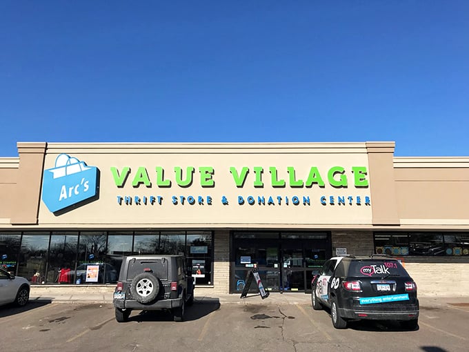 Arc's Value Village glows green against the blue sky. Your wallet will thank you for this colorful detour!