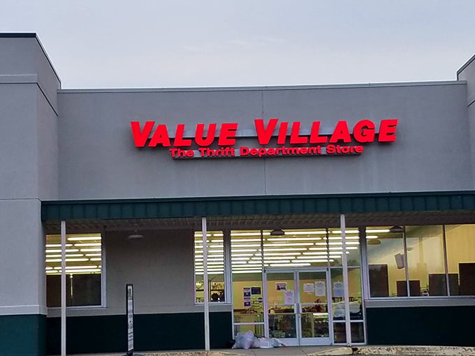 Value Village's bold red sign promises adventures in affordability. Where budget-conscious shoppers become treasure hunters.