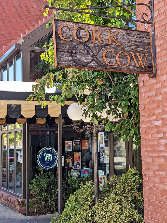 That weathered wooden sign swinging above Cork & Cow hints at the perfect pairing waiting inside. Simplicity at its most sophisticated!