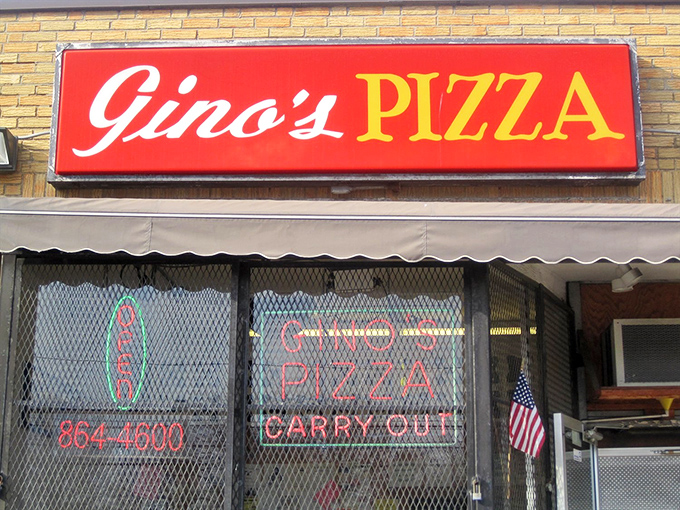Gino's neon glow promises pizza salvation to weary travelers. The simple exterior hides extraordinary flavors within.