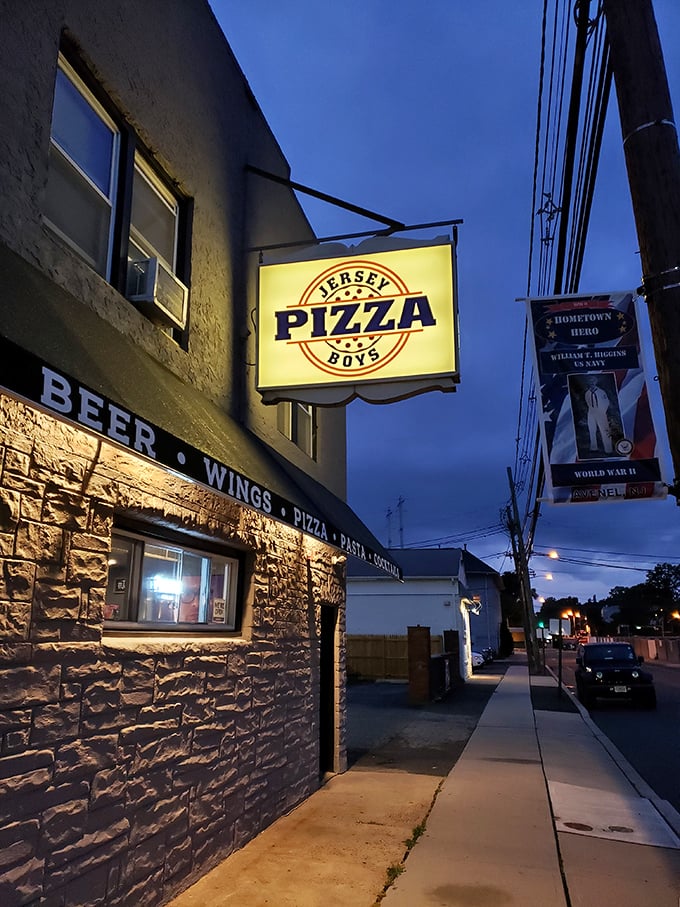 Jersey Pizza Boys' illuminated sign cuts through the night &ndash; a bat signal for those seeking serious pizza satisfaction.