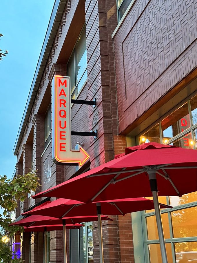 Marquee Pizzeria's glowing arrow sign points the way to wood-fired nirvana and patio perfection.
