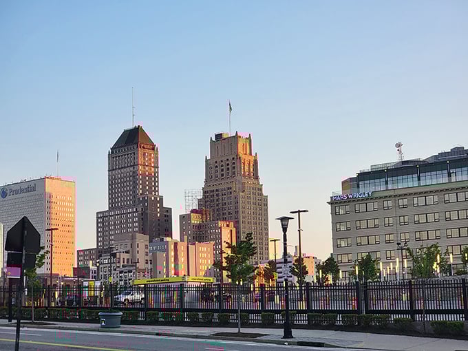 Sunset bathes these historic skyscrapers in golden light - Art Deco dreams against a perfect blue sky.