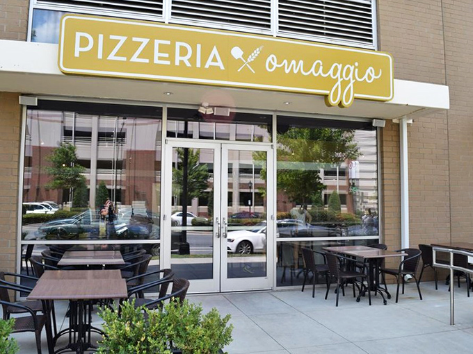 Pizzeria Omaggio's sunny yellow sign brightens the day almost as much as their perfect pizza brightens your mood.