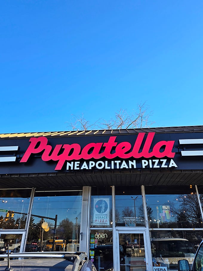 Pupatella's bold red sign promises authentic Neapolitan pizza that would make your Italian grandmother weep with joy.