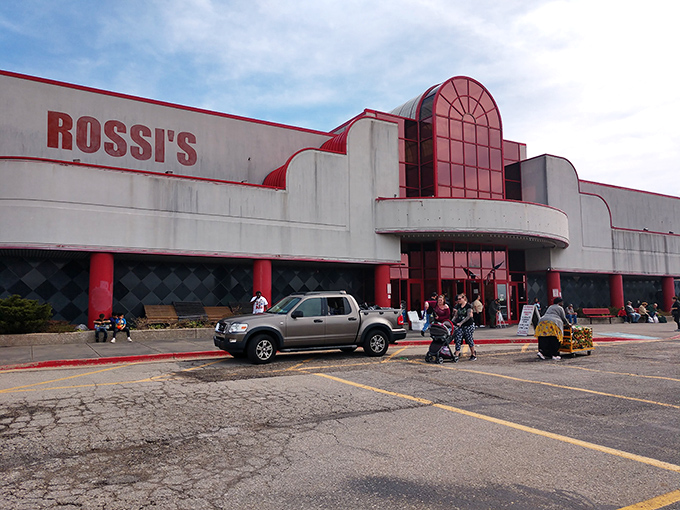 Rossi's distinctive red-trimmed entrance stands like a portal to bargain paradise, beckoning shoppers with promises of hidden treasures inside.