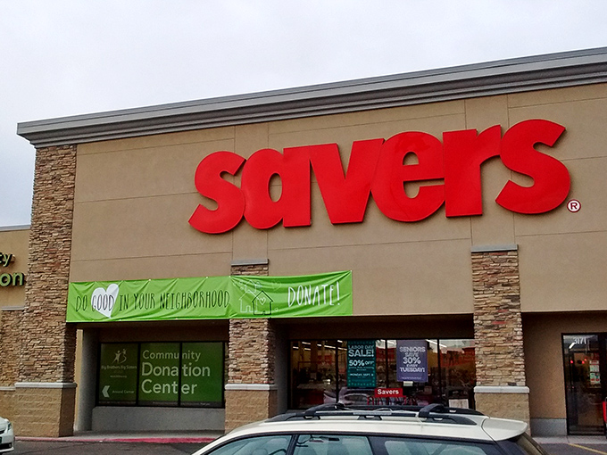 The bold red Savers sign beckons like a lighthouse guiding bargain hunters to shores filled with unexpected treasures.