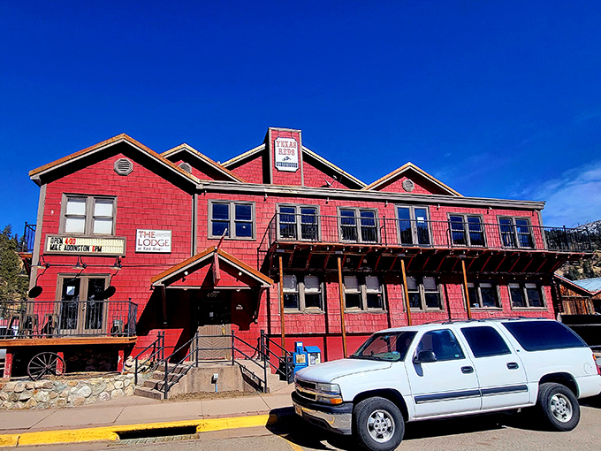 Texas Reds' bold red exterior stands out against the mountain backdrop. It's like a delicious stop sign saying, "Halt! Steaks ahead!"