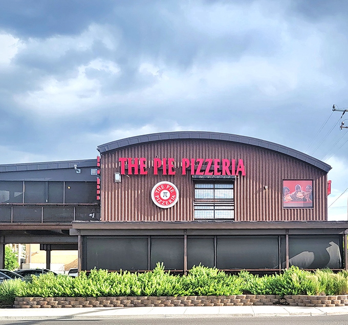 The Pie Pizzeria's curved roof and bold red signage stand out like a beacon for the hungry. Architectural pizza poetry!