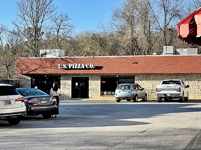 Tommy's Famous blue building stands out like a sapphire in the rough, declaring pizza greatness with bold confidence.