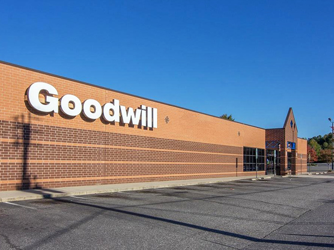 The Goodwill sign shines like a beacon for savvy shoppers. Inside awaits an organized chaos of possibilities.