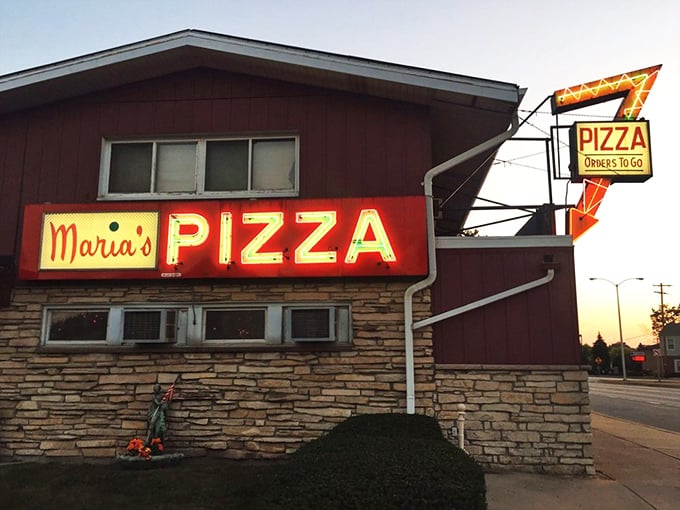The neon arrow points to pizza nirvana. Maria's vintage charm is matched only by their massive oval pies. 
