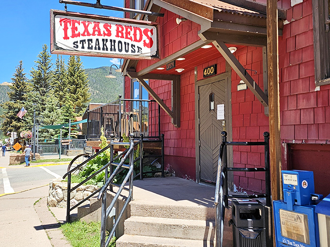 That weathered sign and rustic entrance at Texas Reds &ndash; where mountain charm meets serious steak business. Your stomach is already applauding.