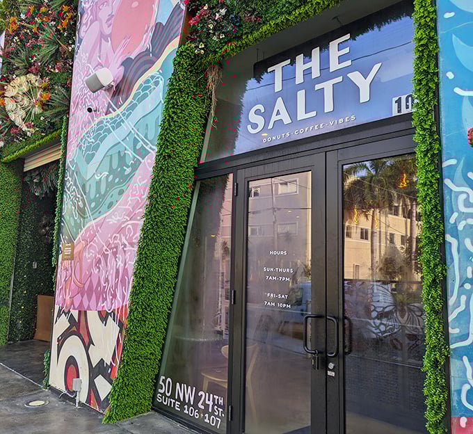 The lush green entrance feels like stepping into a secret garden&mdash;if gardens grew donuts instead of flowers.