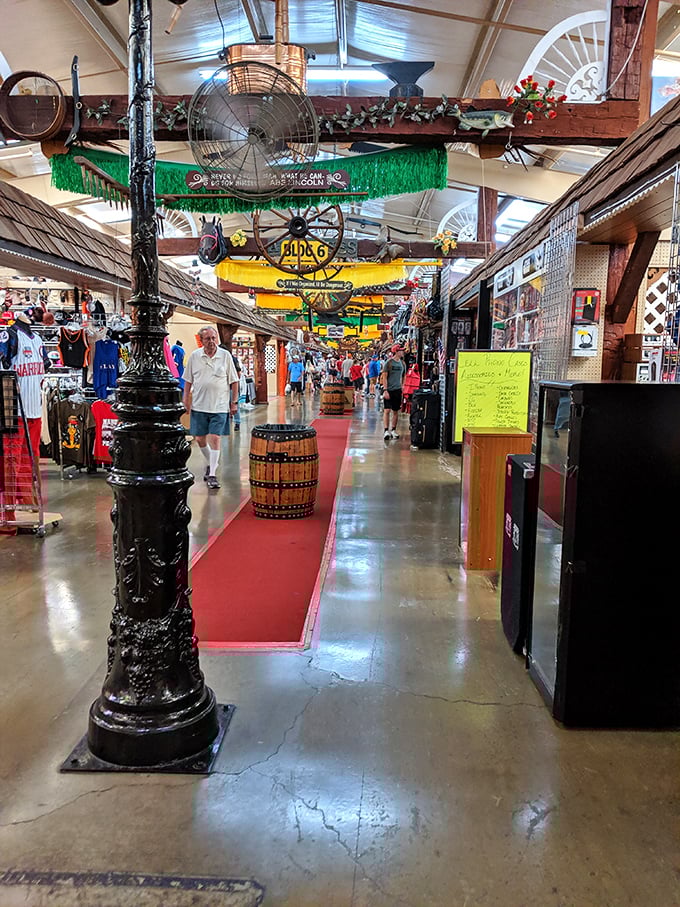 Colorful signs hang overhead at Traders World, guiding shoppers through a labyrinth of potential treasures and nostalgic finds.
