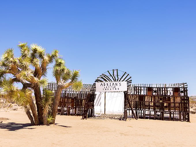 Adrian's Little Theater stands like a desert mirage, its weathered wooden frame creating a stage where only the wind and light perform their daily show.