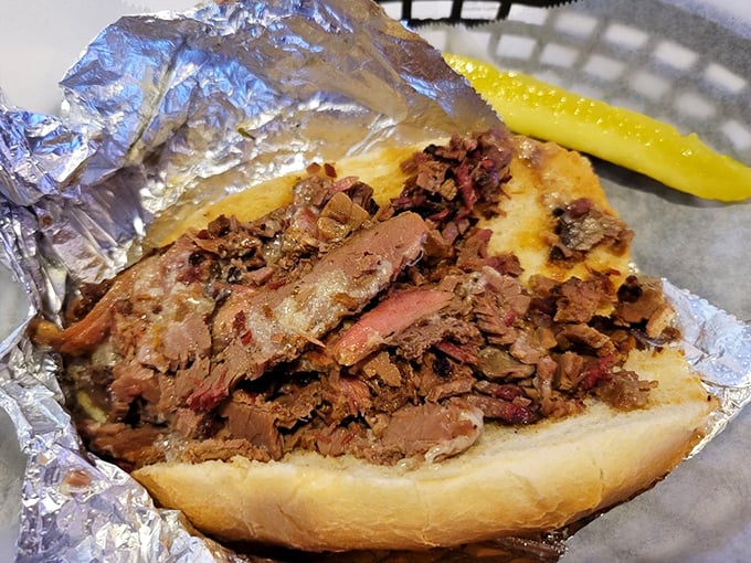 This brisket sandwich isn't just lunch&mdash;it's edible history. Tender meat surrenders to your bite while the pickle stands guard.