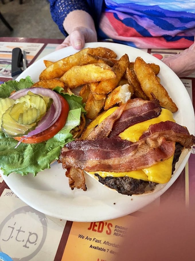 That bacon is doing the backstroke in melted cheese while those fries stand at attention, ready for their moment of glory.