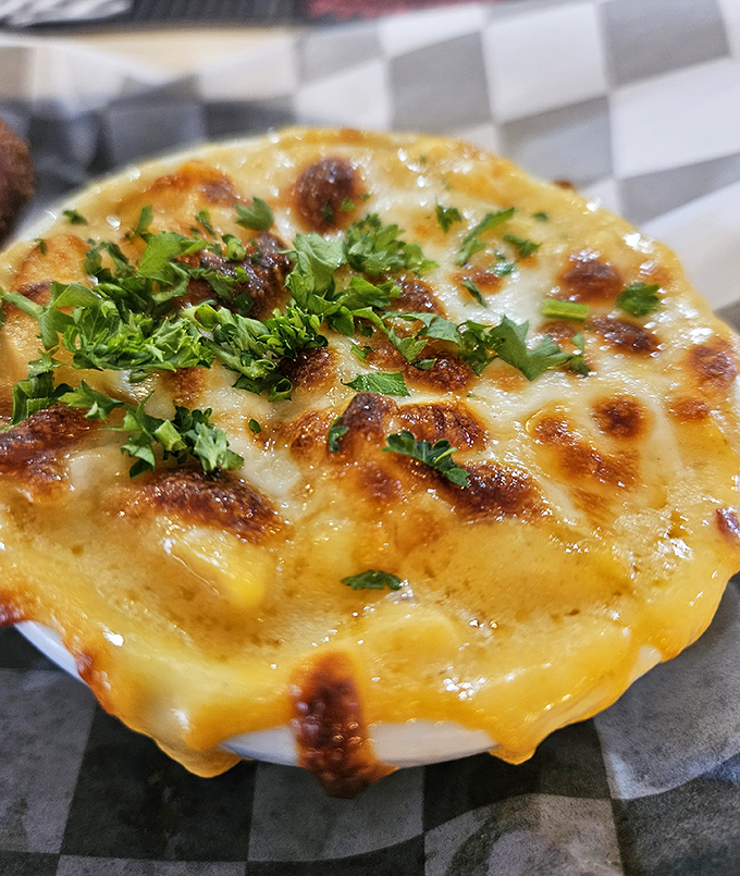 Golden, bubbling perfection in ceramic form. This mac and cheese doesn't just satisfy hunger&mdash;it resolves existential crises one cheesy bite at a time.