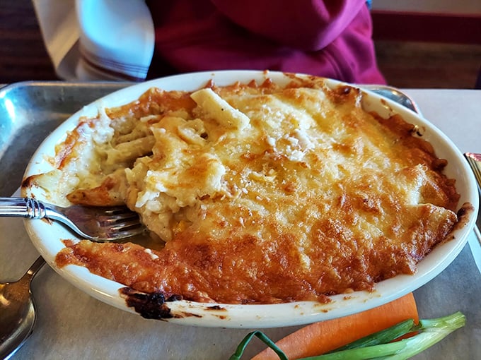 Behold the mac and cheese in all its golden glory &ndash; a bubbling cauldron of creamy perfection that makes grown adults fight over the crispy edges.