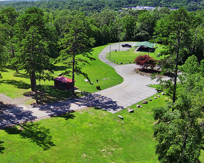 Winding pathways invite leisurely strolls through Ballou Park's verdant landscape, where towering trees provide perfect shade for summer picnics.