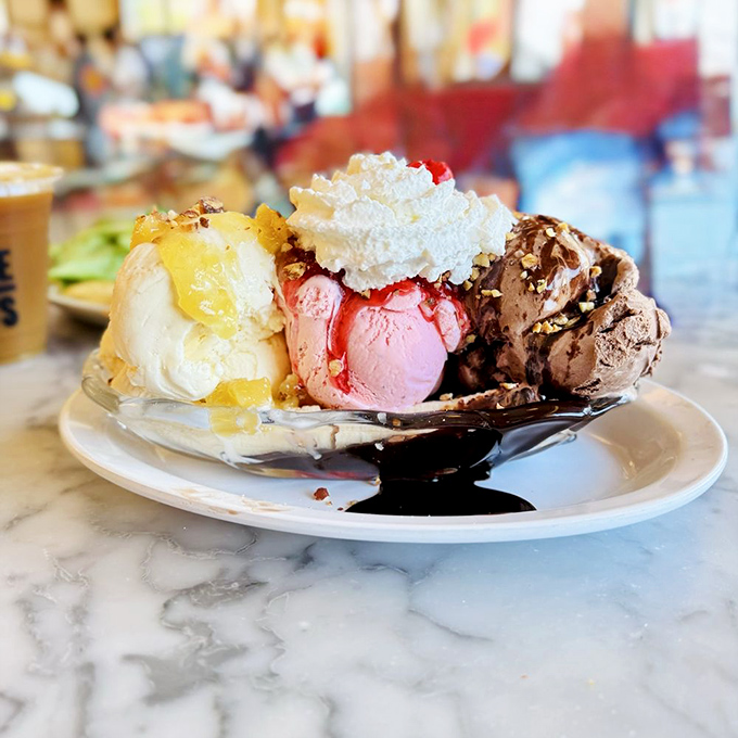 Not so much a dessert as an expedition—multiple scoops of ice cream flanked by toppings and crowned with whipped cream.