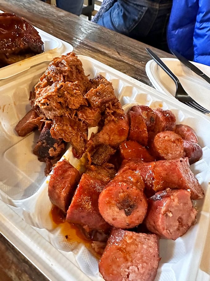 Meat candy for grown-ups! This platter of pulled pork and sausages delivers that perfect marriage of smoke, spice, and everything nice.
