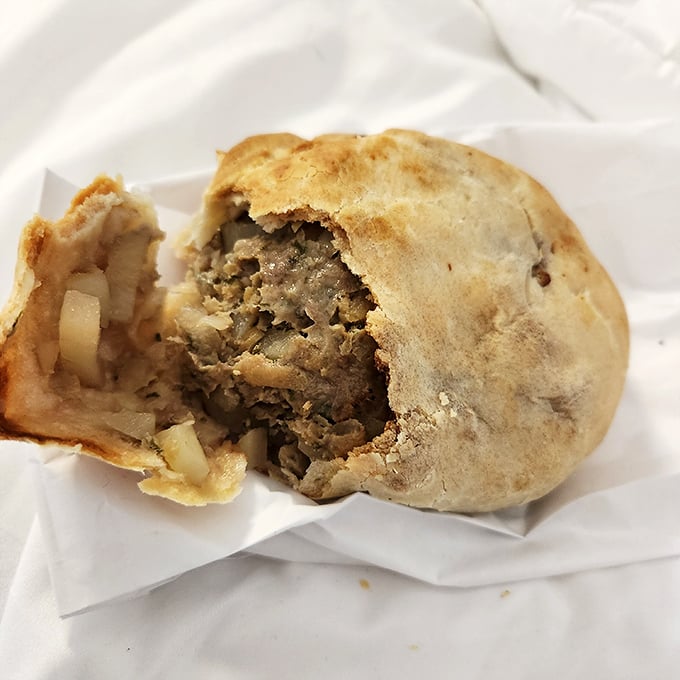 The cross-section reveals the truth&mdash;a perfect ratio of seasoned beef to vegetables, all tucked into that golden-brown pastry embrace.