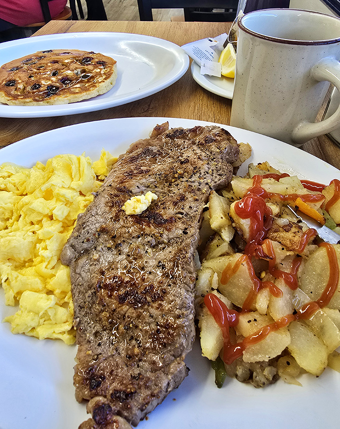 Behold the Big Breakfast: two pancakes, perfectly cooked eggs, and enough protein to fuel your day.