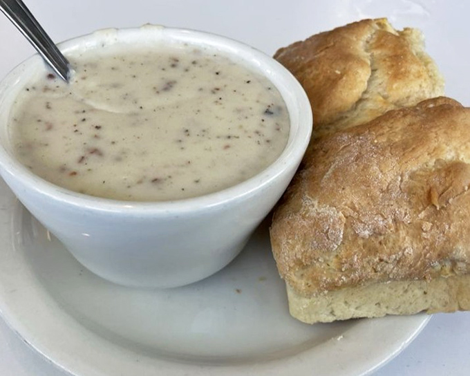 Behold the star attraction: biscuits and gravy that would make your grandmother both proud and jealous. Golden, fluffy perfection meets savory, peppery bliss.