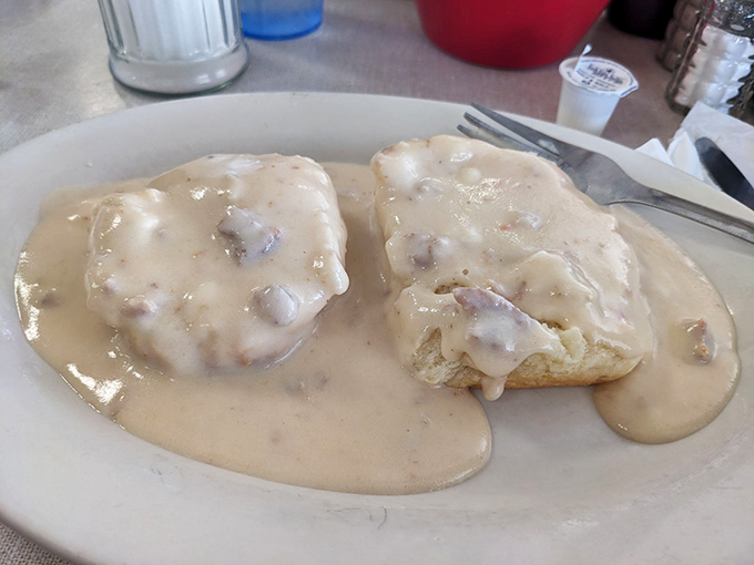 Biscuits swimming in creamy sausage gravy – a Southern baptism that transforms ordinary mornings into occasions worth getting out of bed for.