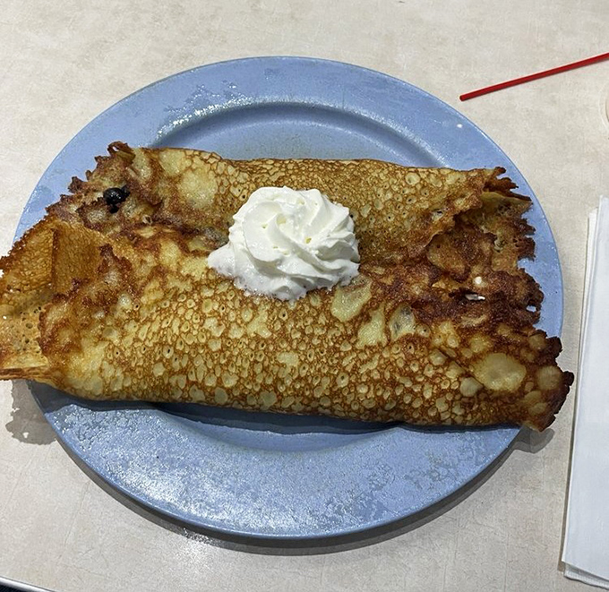 Blueberry pancakes that could make your grandmother jealous &ndash; thin, crispy-edged perfection crowned with fresh berries and a dusting of powdered sugar.