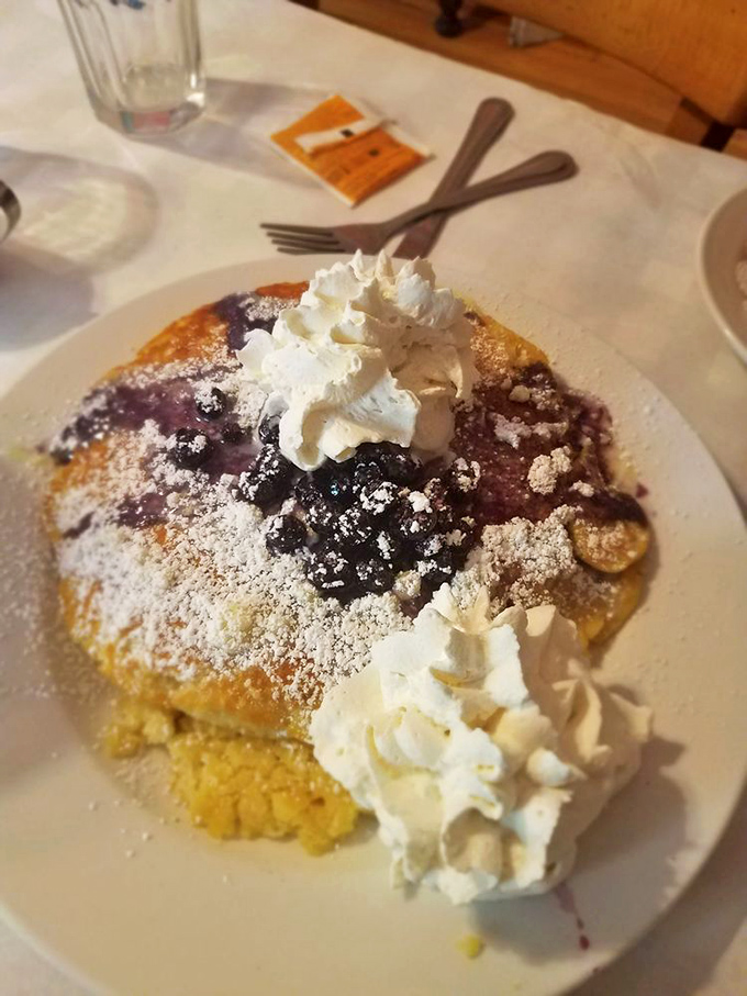 Blueberry pancakes crowned with clouds of whipped cream&mdash;proof that sometimes the best things in life require both a fork and napkin.