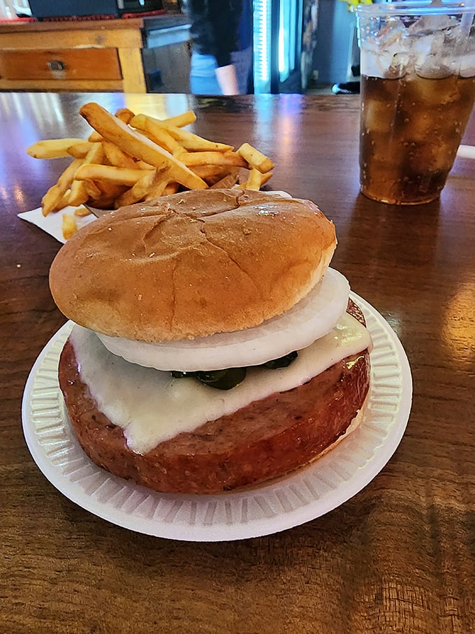 Behold the star attraction: a thick-cut slab of grilled bologna, crowned with cheese, sweet onion, and pickle relish on a pillowy bun. Poetry in processed meat form. 