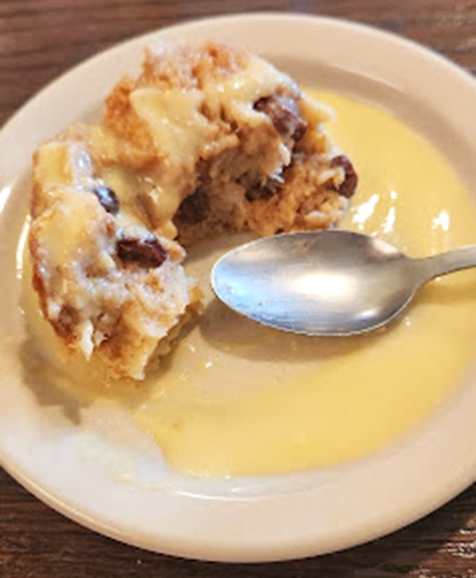 Bread pudding swimming in vanilla sauce: proof that dessert is really just breakfast that stayed up late and put on fancy clothes.